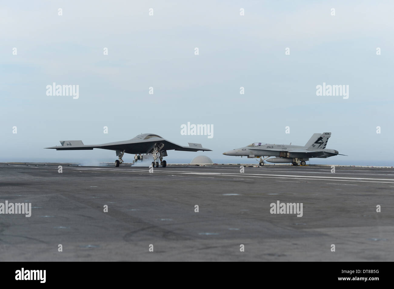 An X-47B unmanned combat air system conducts a touch and go landing ...