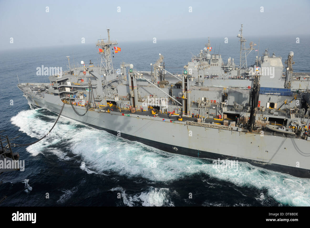 USNS Rainier transits alongside USS Nimitz during a replenishment at ...