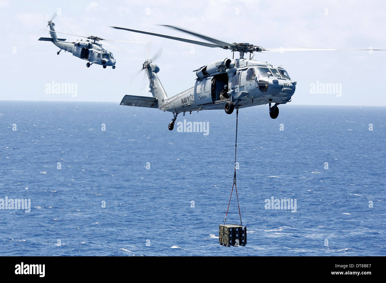 MH-60S Sea Hawk helicopters conduct a vertical replenishment Stock ...