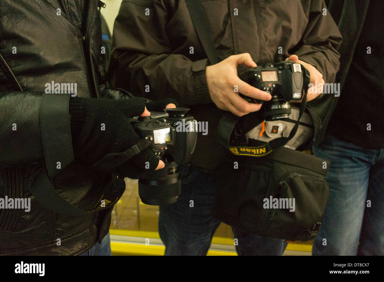 Photographers checking their camera settings Stock Photo - Alamy