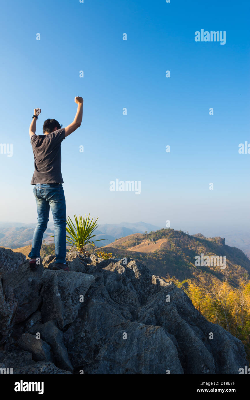 man standing on stone top of high mountain Stock Photo - Alamy