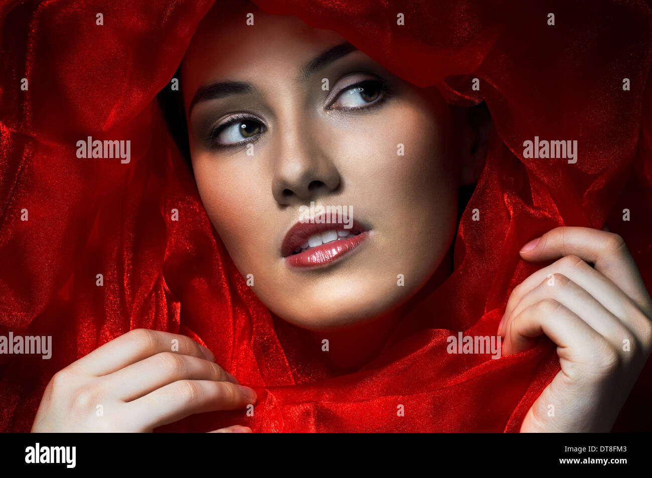 beautiful girl in the red fabric Stock Photo - Alamy