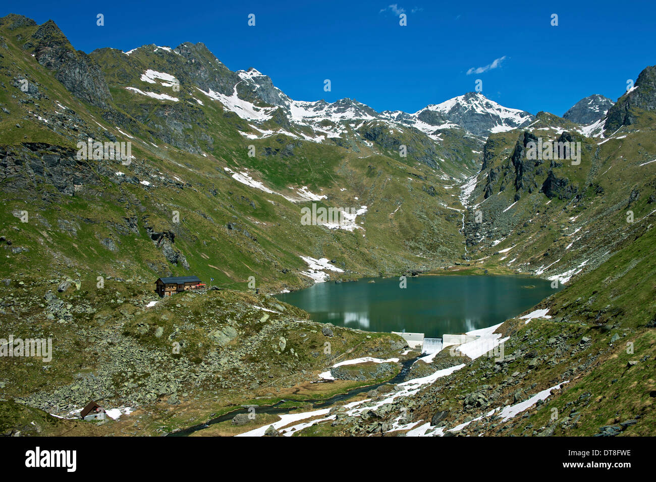 Mountain hut Cabane de Louvie at lake Louvie, peak Becca d'Agè behind ...