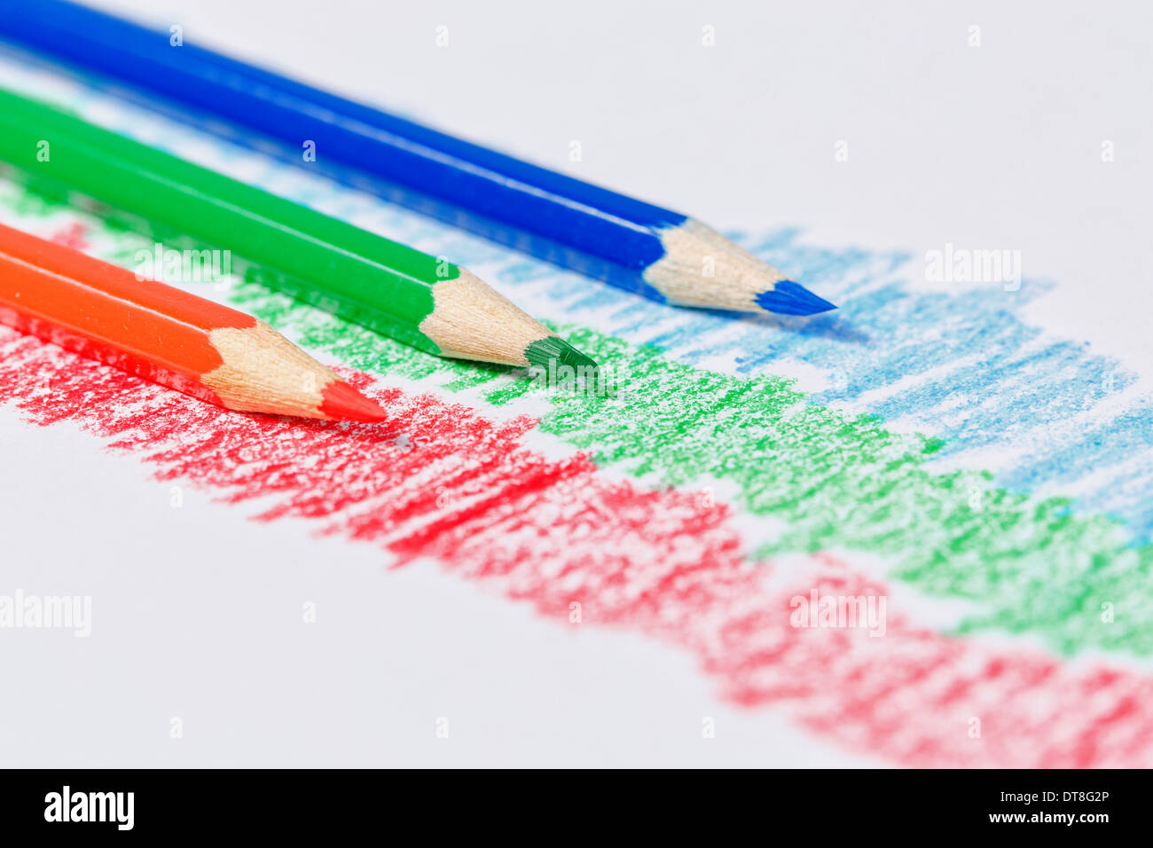 RGB pencils and abstract lines of red, green and blue color on textured ...