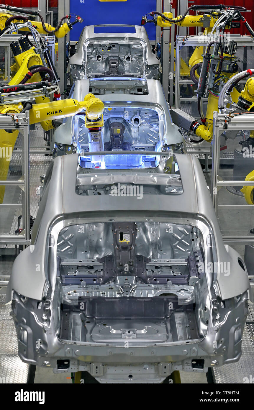 Industrial robots manufacture the bodywork of a new Porsche Macan at ...