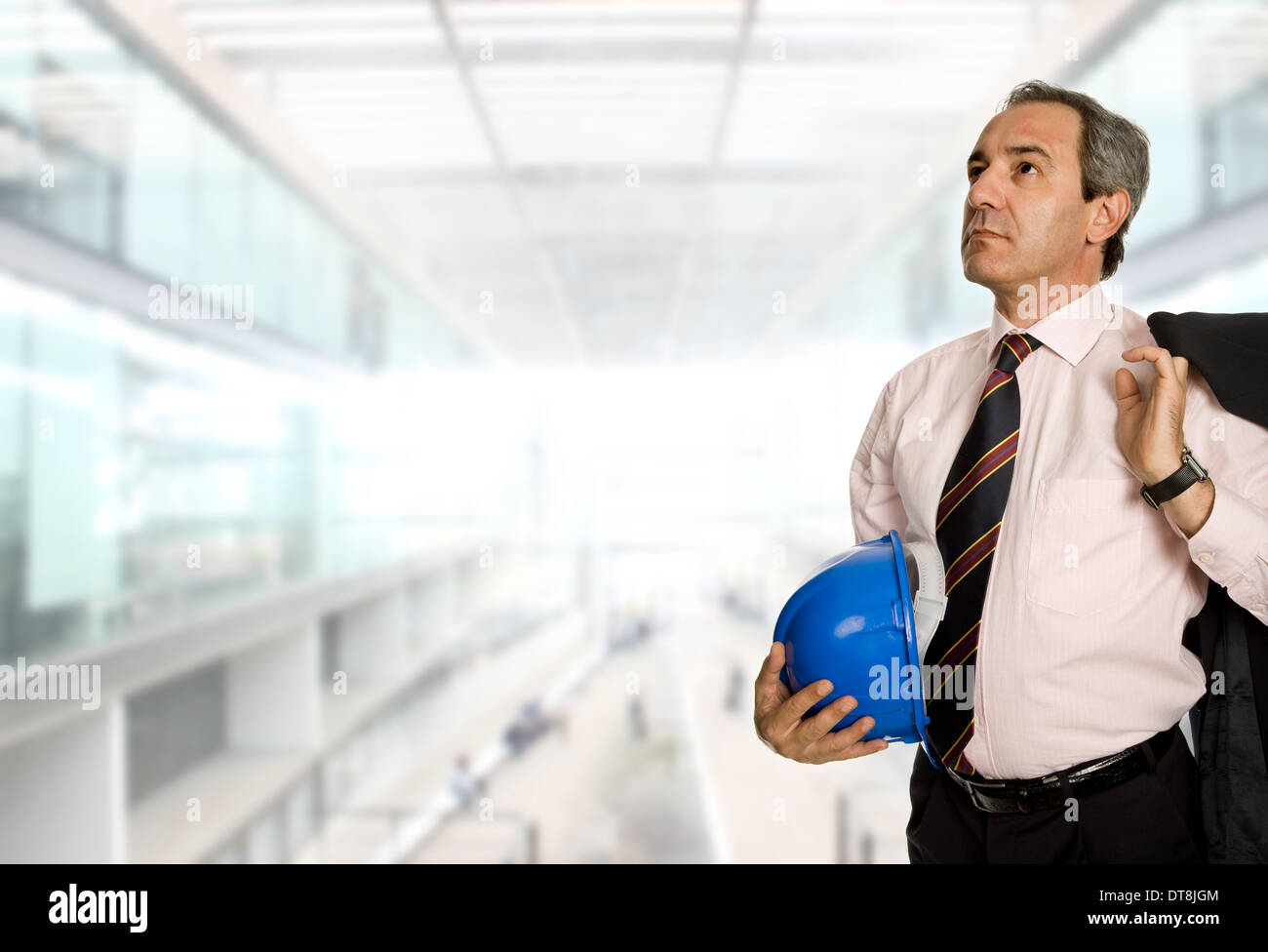 An engineer with blue hat at the office Stock Photo - Alamy