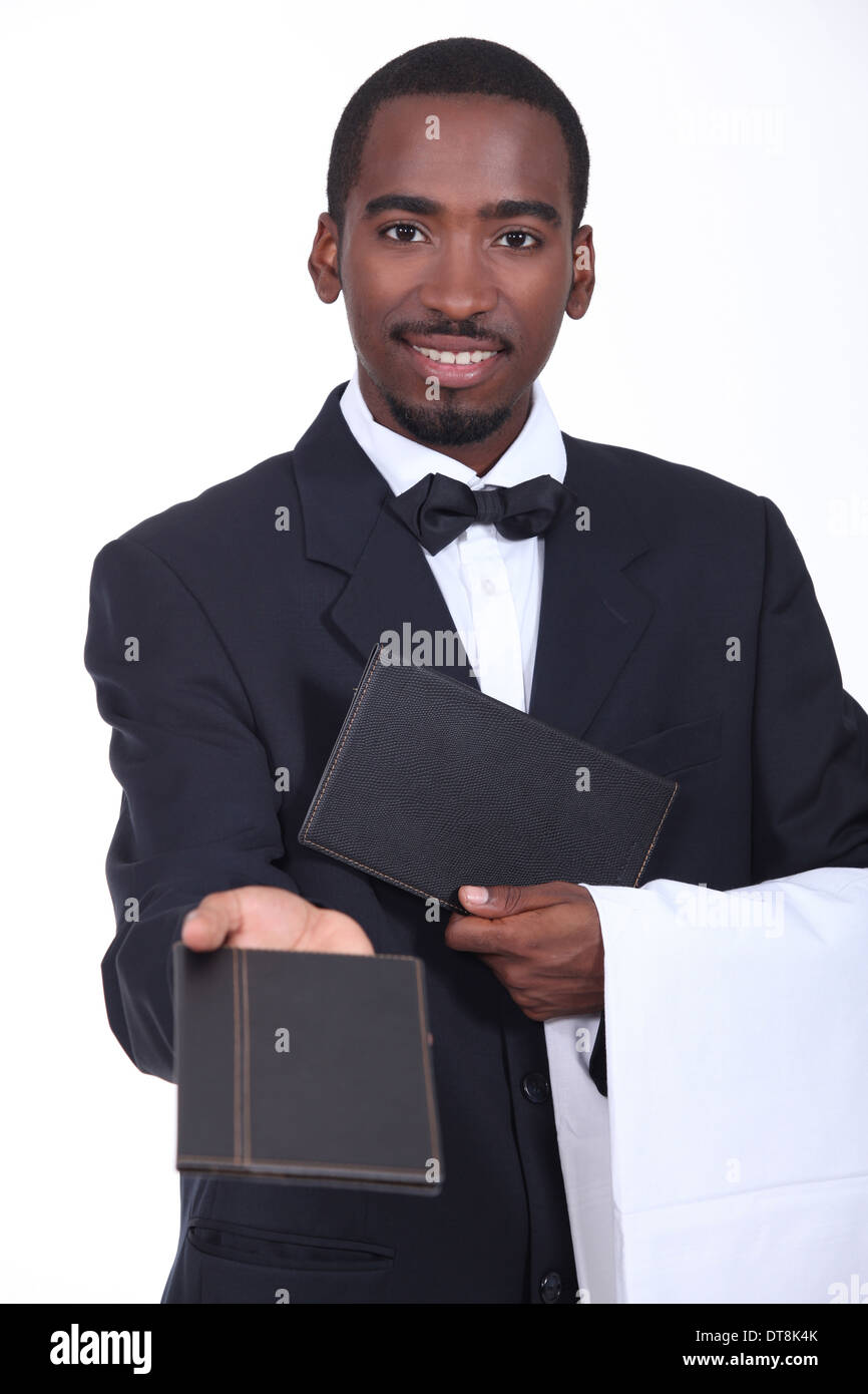 Waiter offering a menu Stock Photo - Alamy