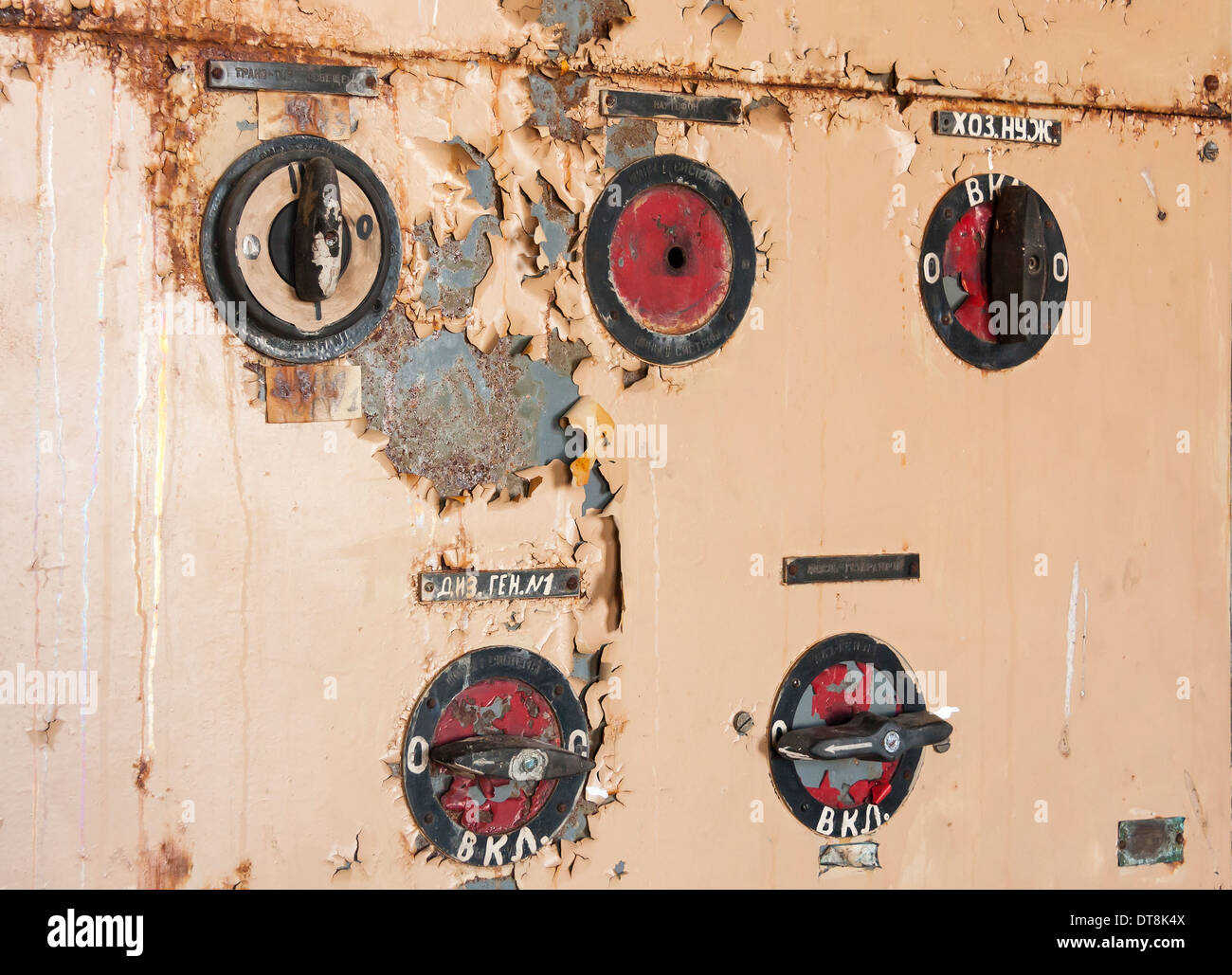 Closeup of an old machine switches in metal plate with peeling paint ...
