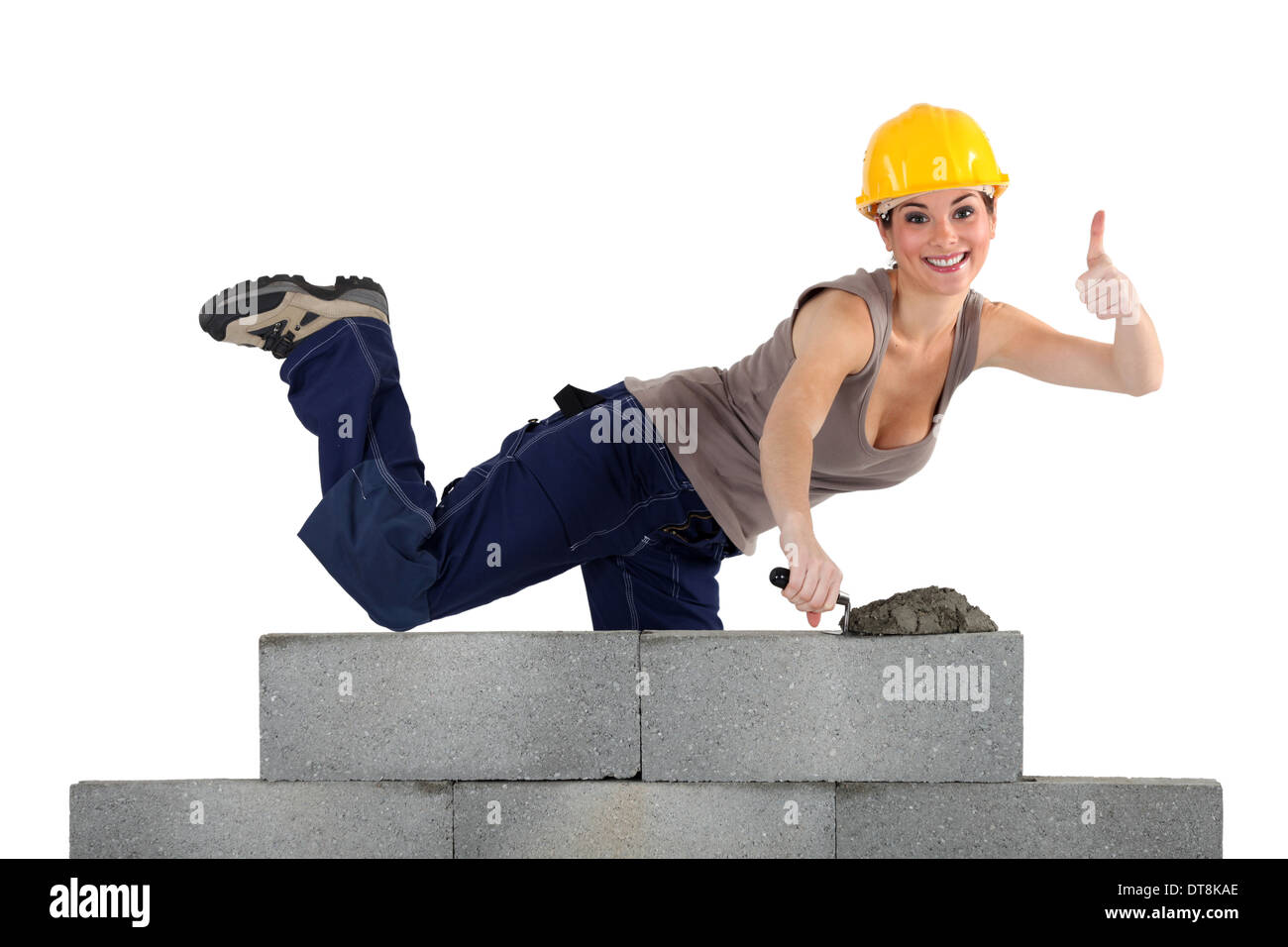 Pirouetting female mason behind wall Stock Photo - Alamy