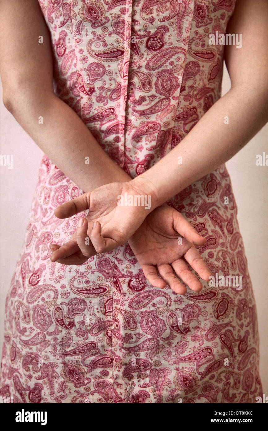 Pink Dress Girl Hands with Fingers crossed Stock Photo - Alamy