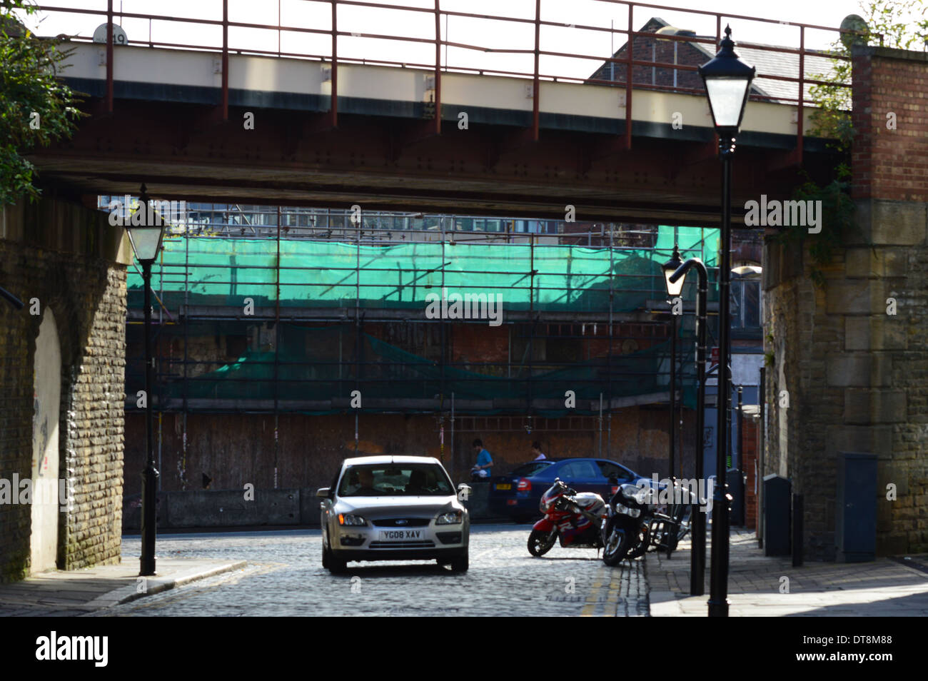CAR UNDER ARCHES LEEDS DEPICTING COBBLED STREET Stock Photo - Alamy