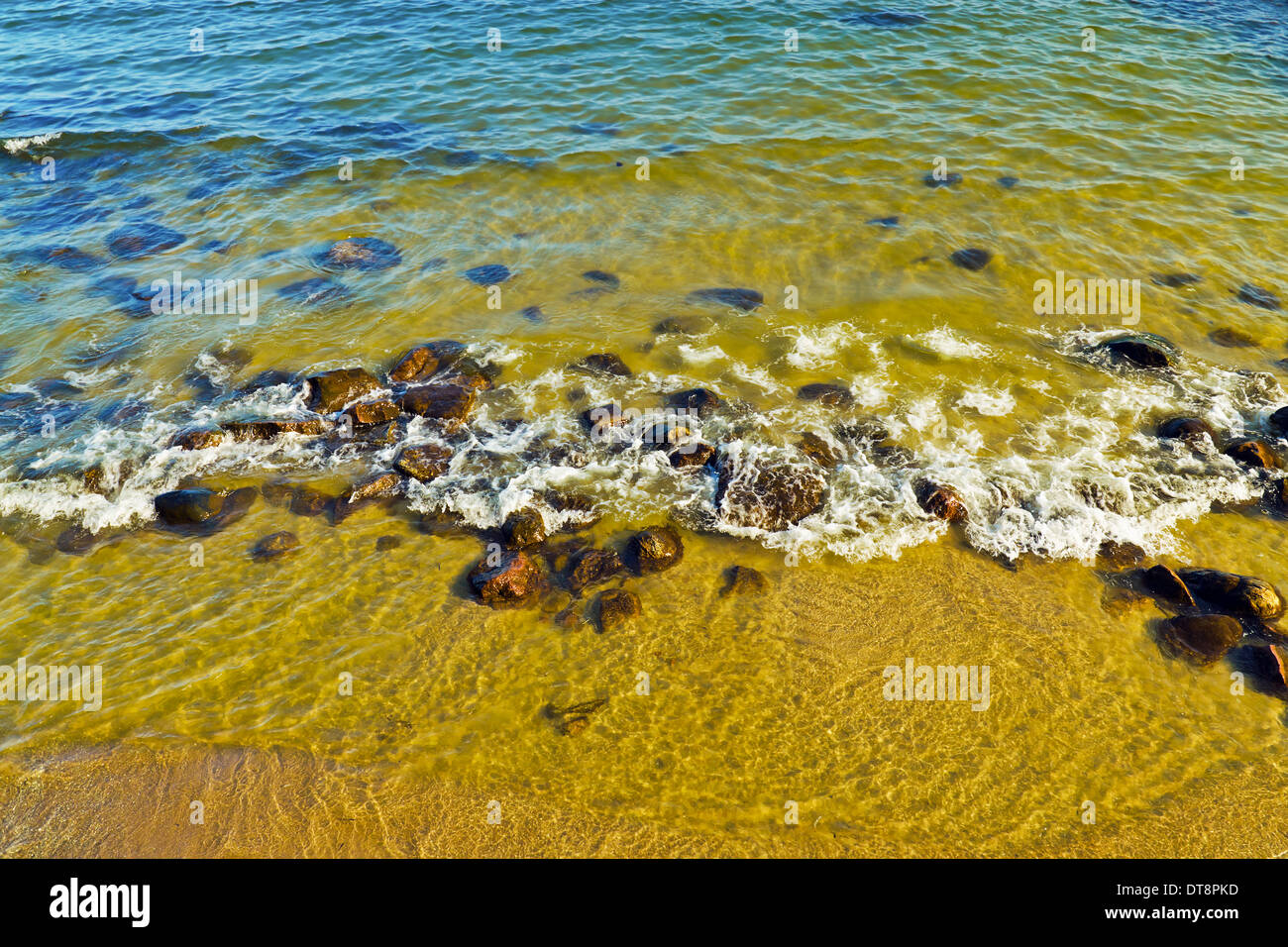 Beautiful sea wave and sandy golden beach Stock Photo - Alamy