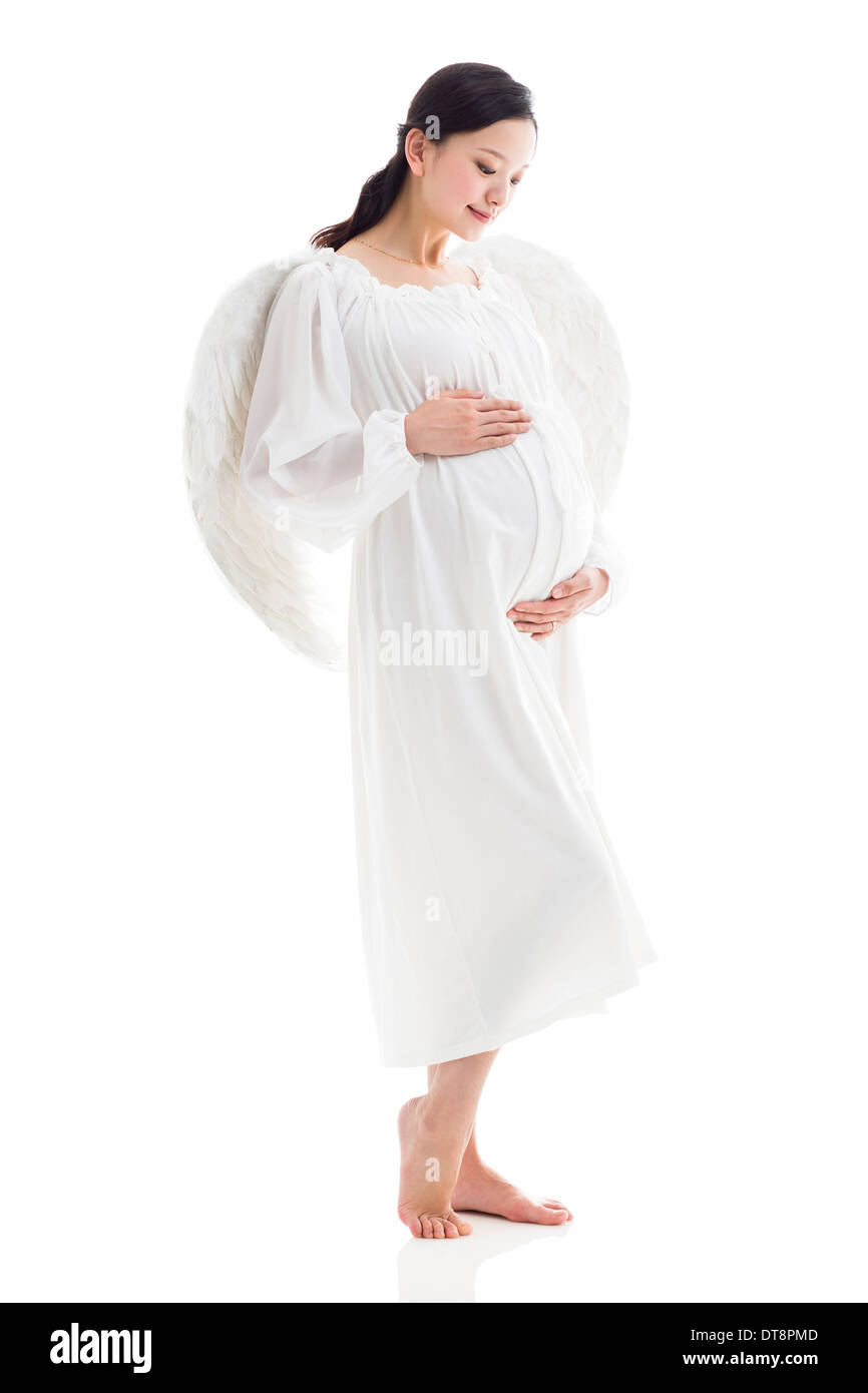 Pregnant woman wearing angel wings Stock Photo - Alamy