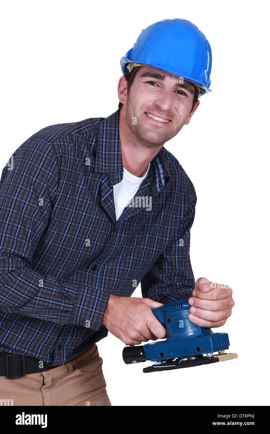 Workman with an electric sander Stock Photo - Alamy