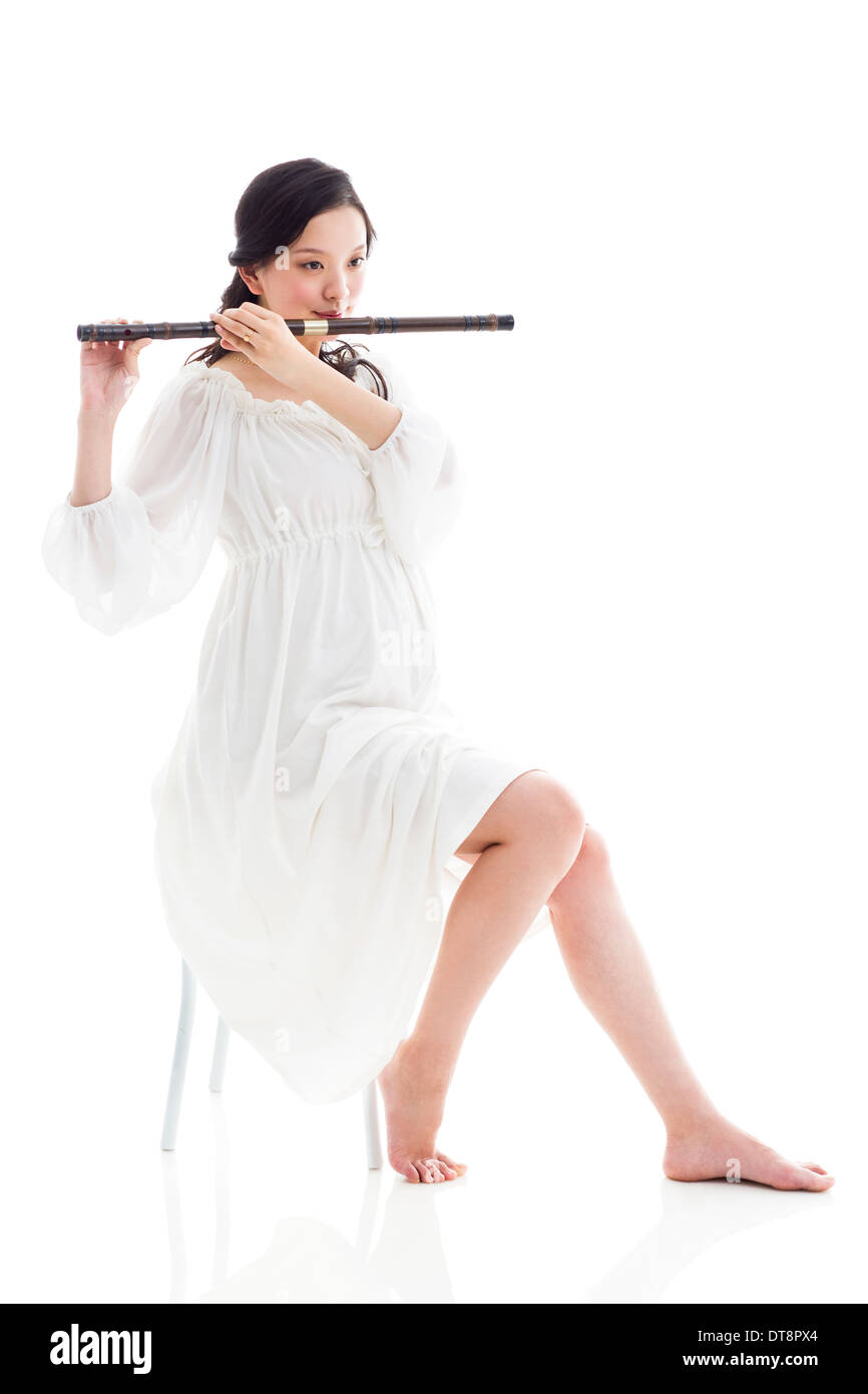 Pregnant woman playing flute Stock Photo - Alamy