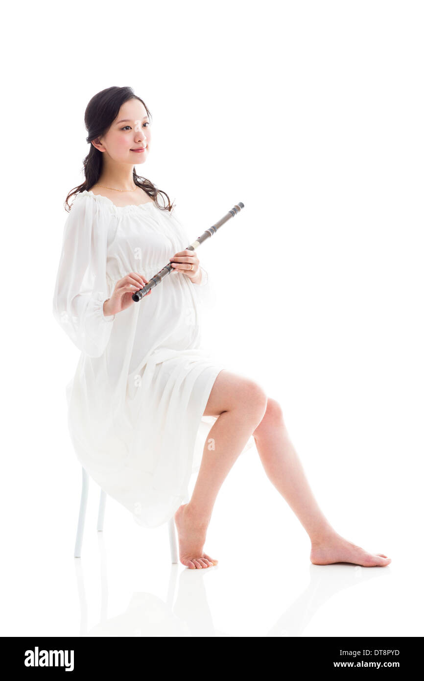 Pregnant woman playing flute Stock Photo - Alamy