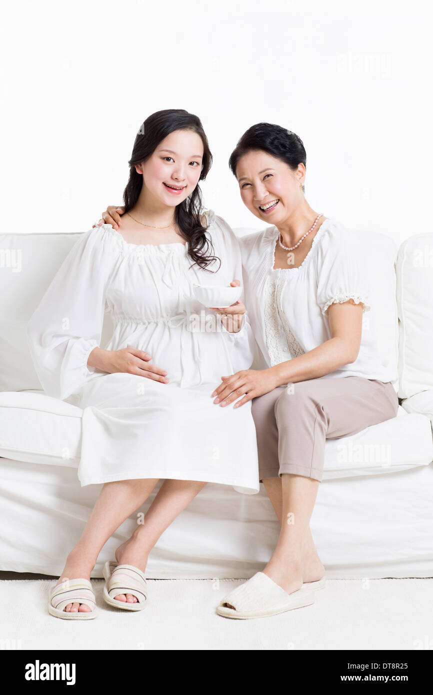 Senior woman taking care of pregnant woman Stock Photo - Alamy