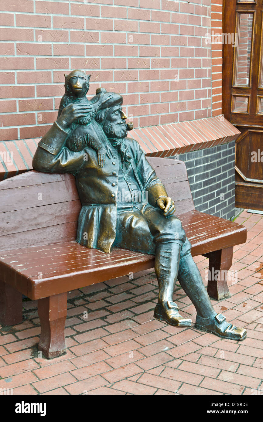 Old skipper with a monkey and a pipe resting on the bench. Fishing ...