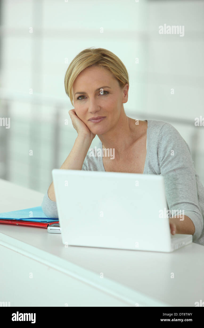 Blond woman with computer Stock Photo - Alamy