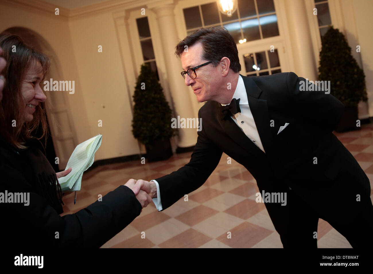 Actor and television host Stephen Colbert, right, greets a member of ...