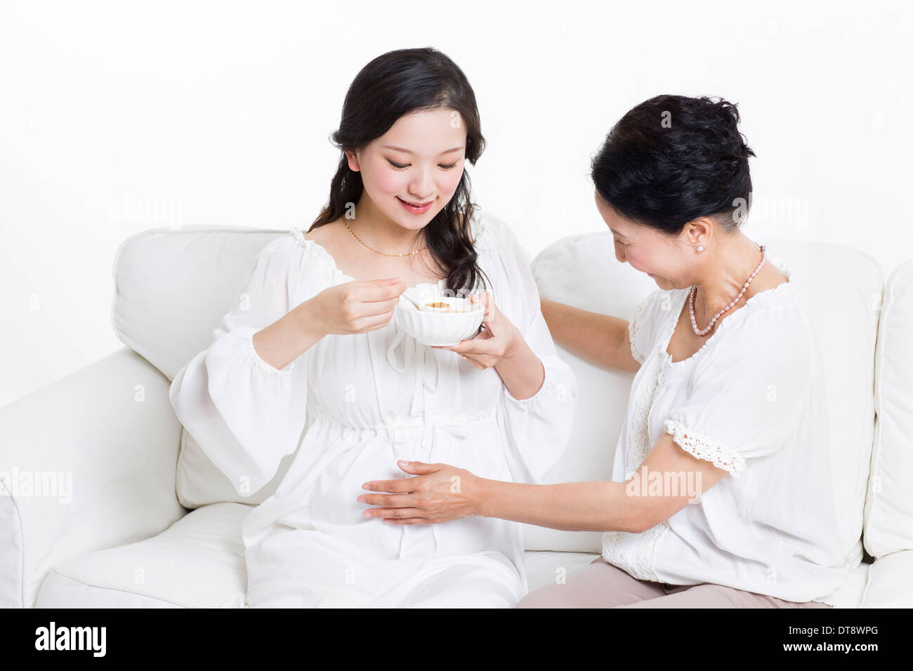 Senior woman taking care of pregnant woman Stock Photo - Alamy