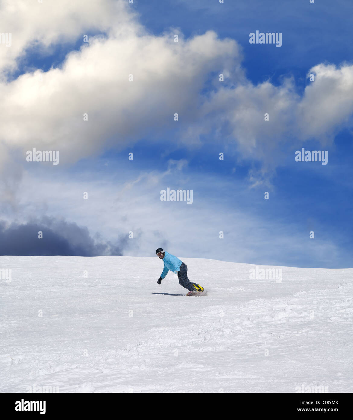 Snowboarder on ski slope and blue sky with clouds in sun day Stock ...
