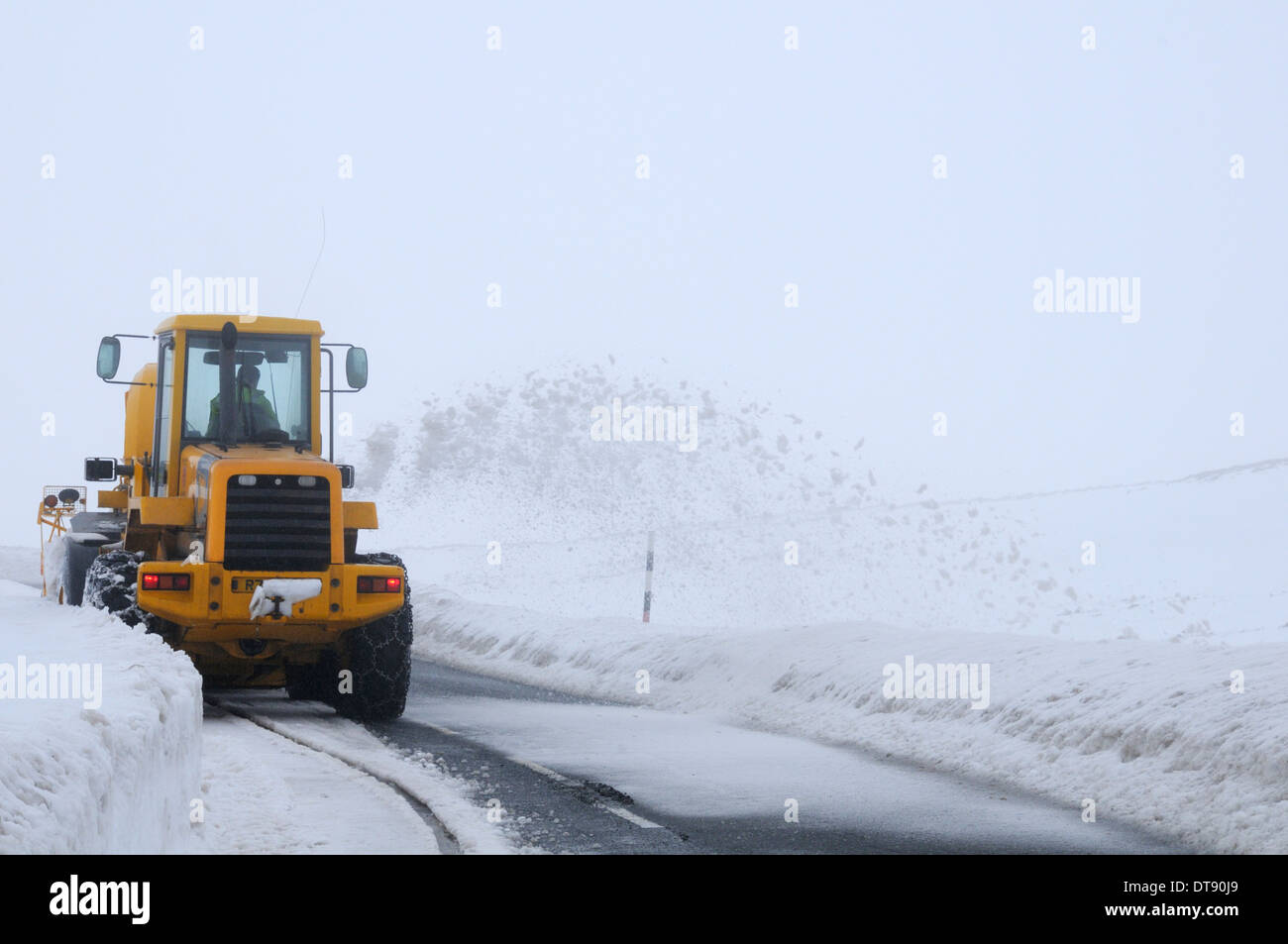Snowblower clearing deep snow on a hillside road Northumberland North ...