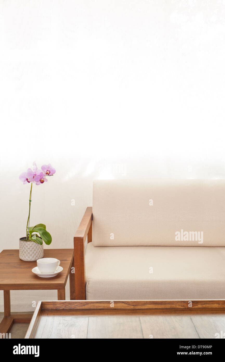 Bright white seater in lounge area with curtain Stock Photo - Alamy