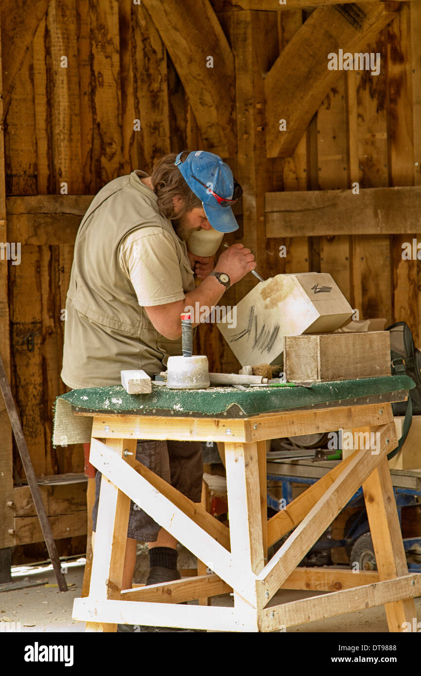 Stonemason at work on black of stone for restoration work at York ...