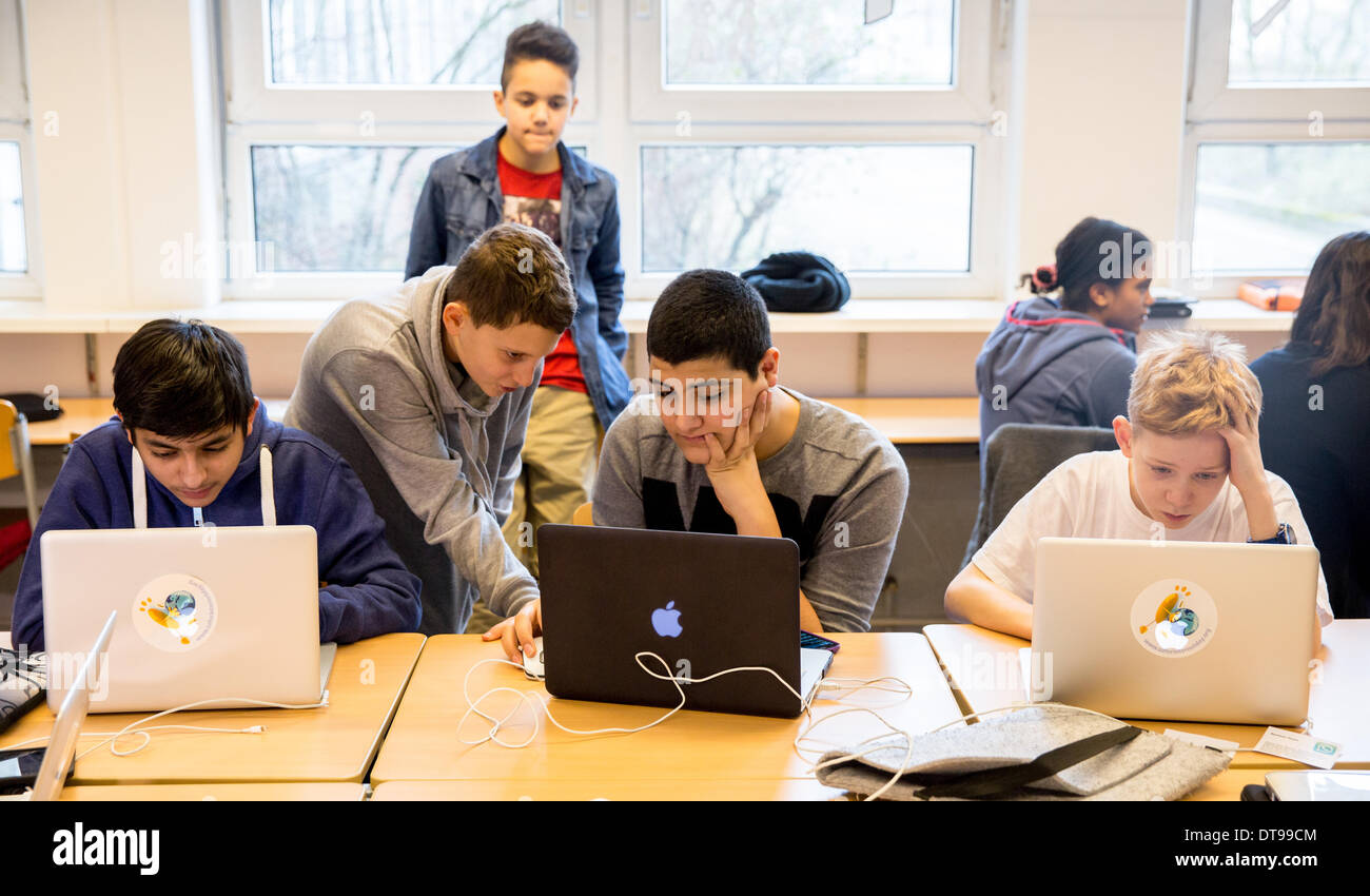 Berlin, Germany. 11th Feb, 2014. Students work with their notebooks at ...