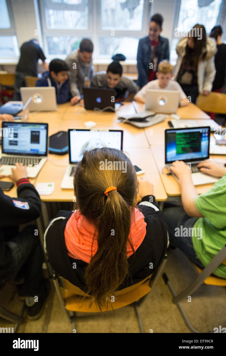 Berlin, Germany. 11th Feb, 2014. Students work with their notebooks at ...