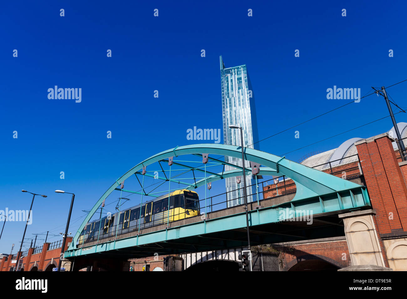 Manchester metro link train crossing the Bridgewater Bridge at the side ...