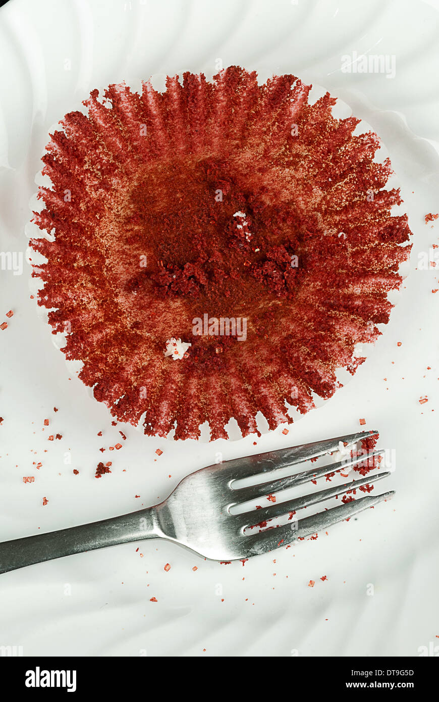 Close-up of an empty red velvet cupcake wrapper lying on a plate ...