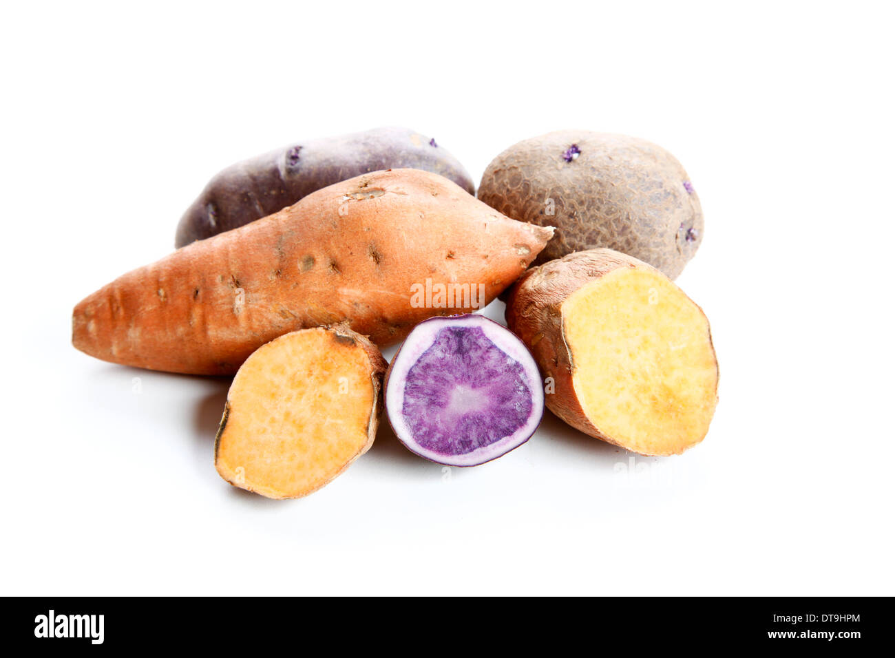 violet potatoes and yam on a white background Stock Photo - Alamy