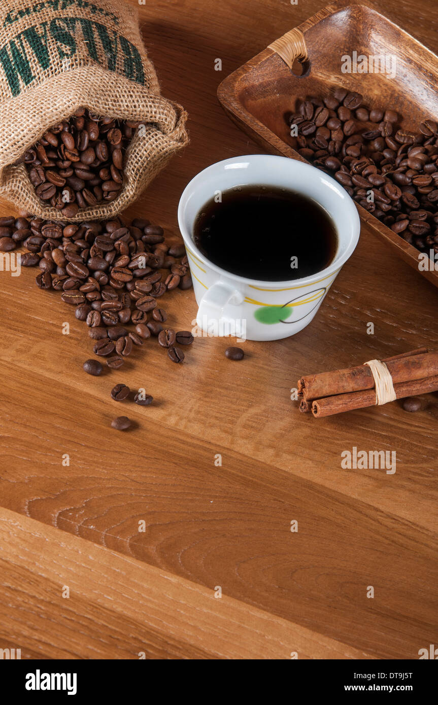 Coffee theme with wooden table and dark background Stock Photo - Alamy