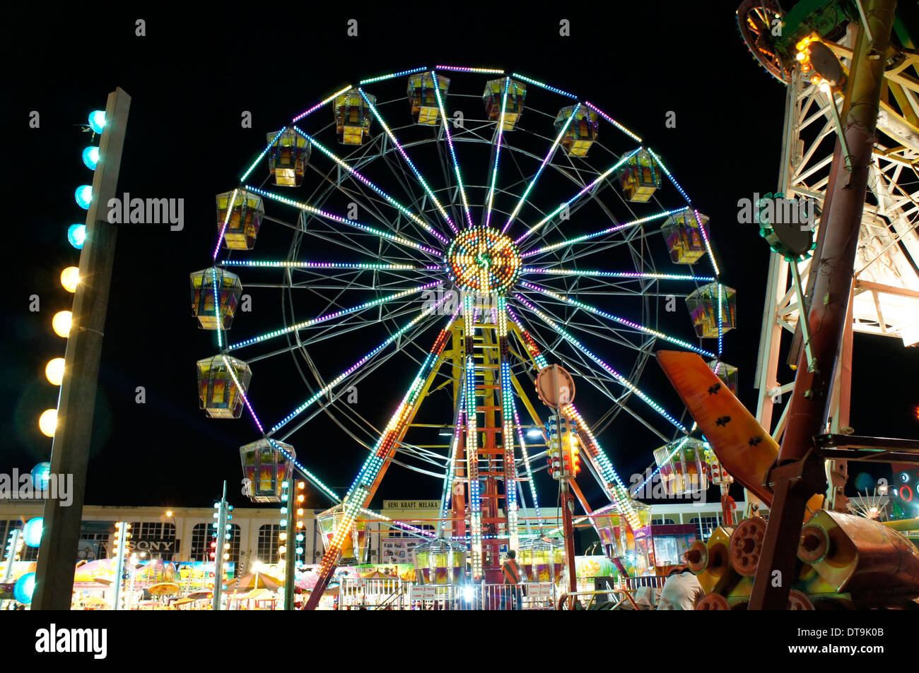 ferris wheel at night fun fair, Malacca Stock Photo - Alamy