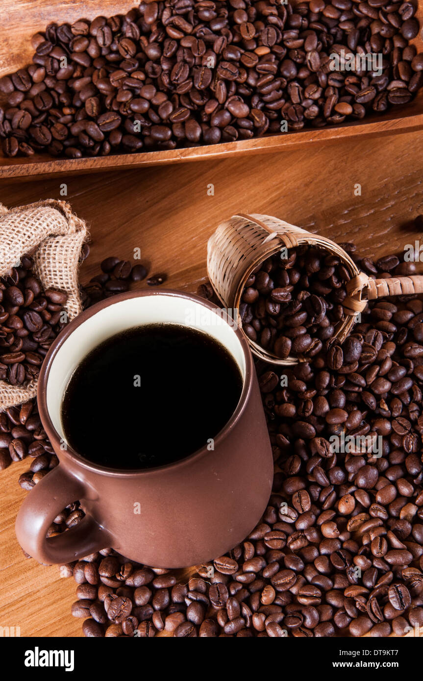 Coffee theme with wooden table and dark background Stock Photo - Alamy