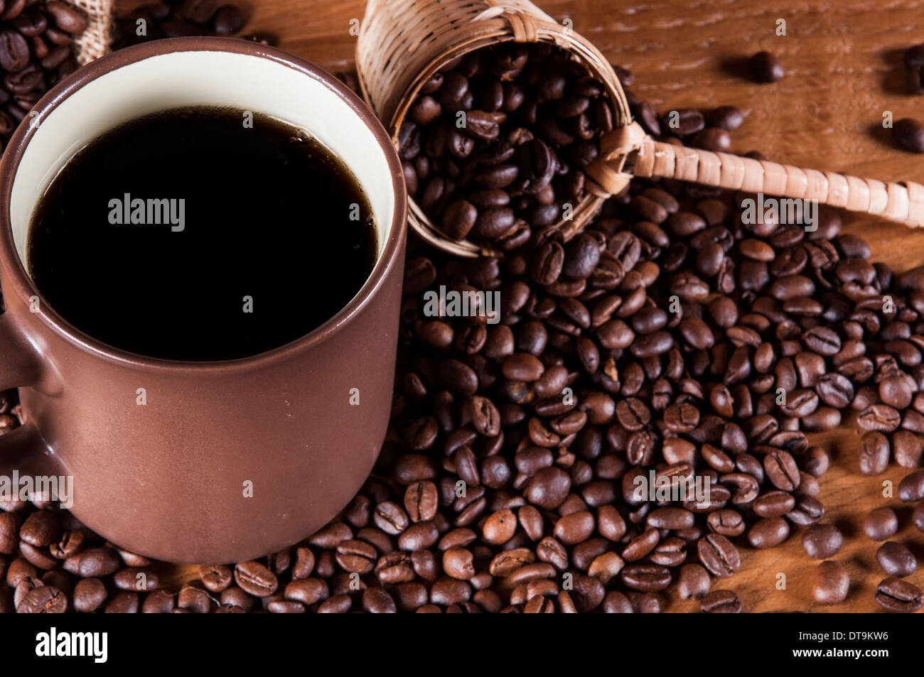 Coffee theme with wooden table and dark background Stock Photo - Alamy
