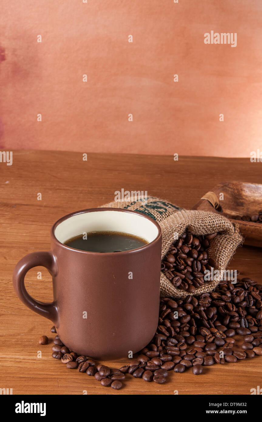 Coffee theme with wooden table and dark background Stock Photo - Alamy