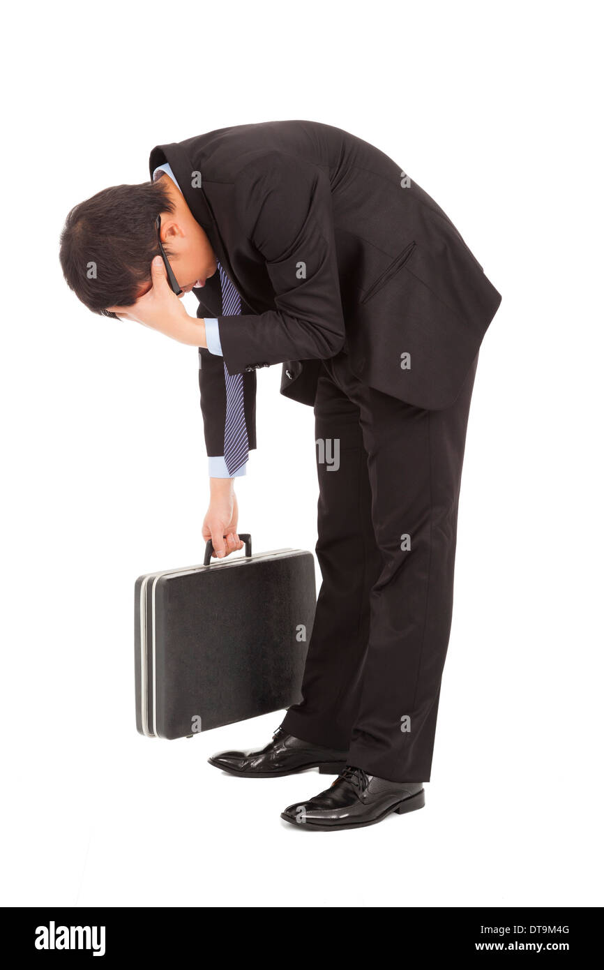 afflictive businessman stoop and hold his head in sutdio Stock Photo ...