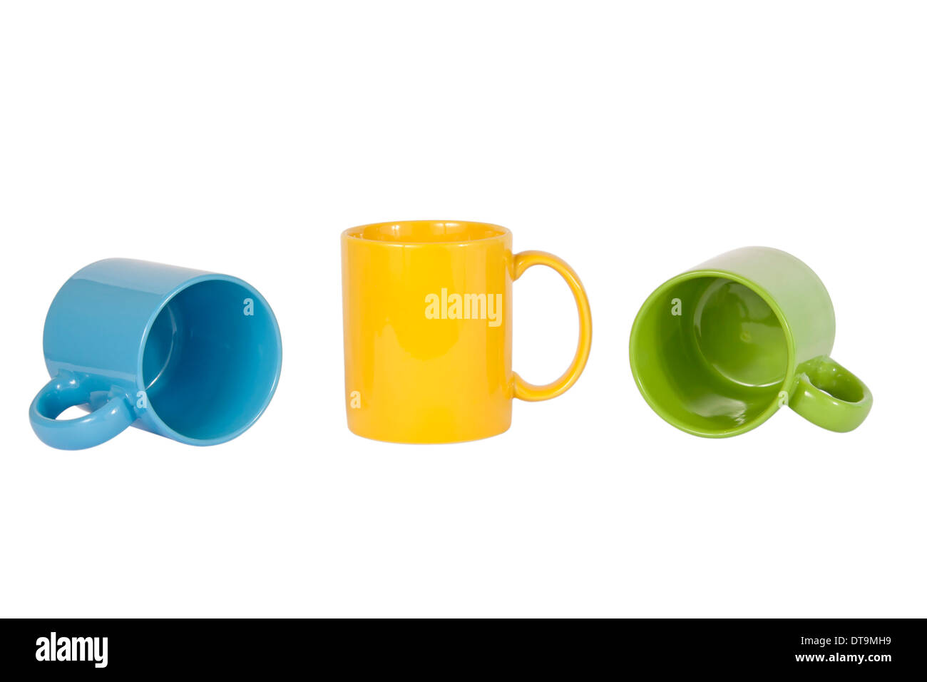 Three cups, one blue, one yellow and one green, isolated on white ...
