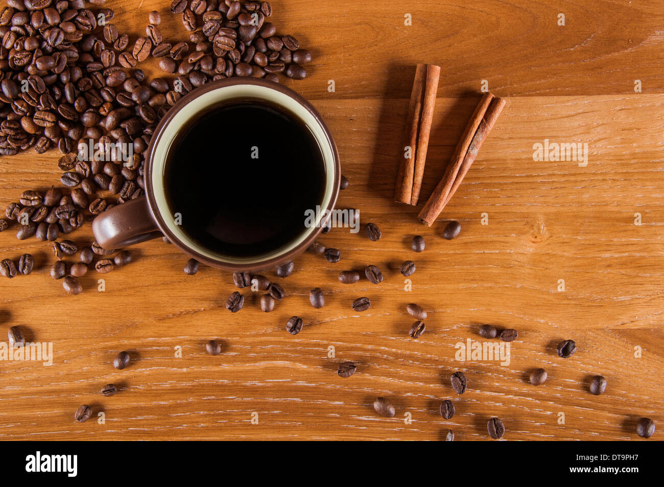 Coffee theme with wooden table and dark background Stock Photo - Alamy