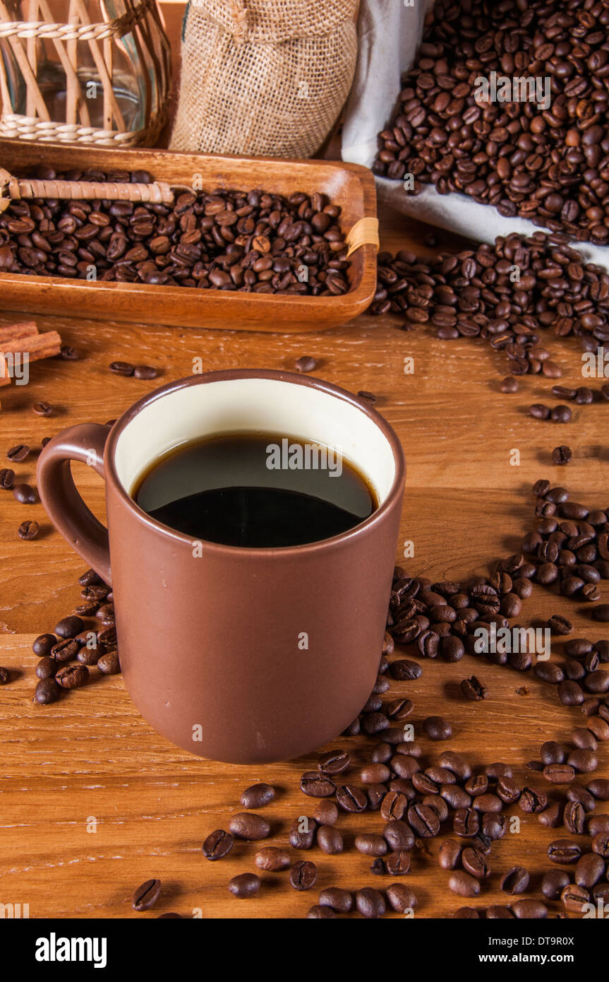 Coffee theme with wooden table and dark background Stock Photo - Alamy