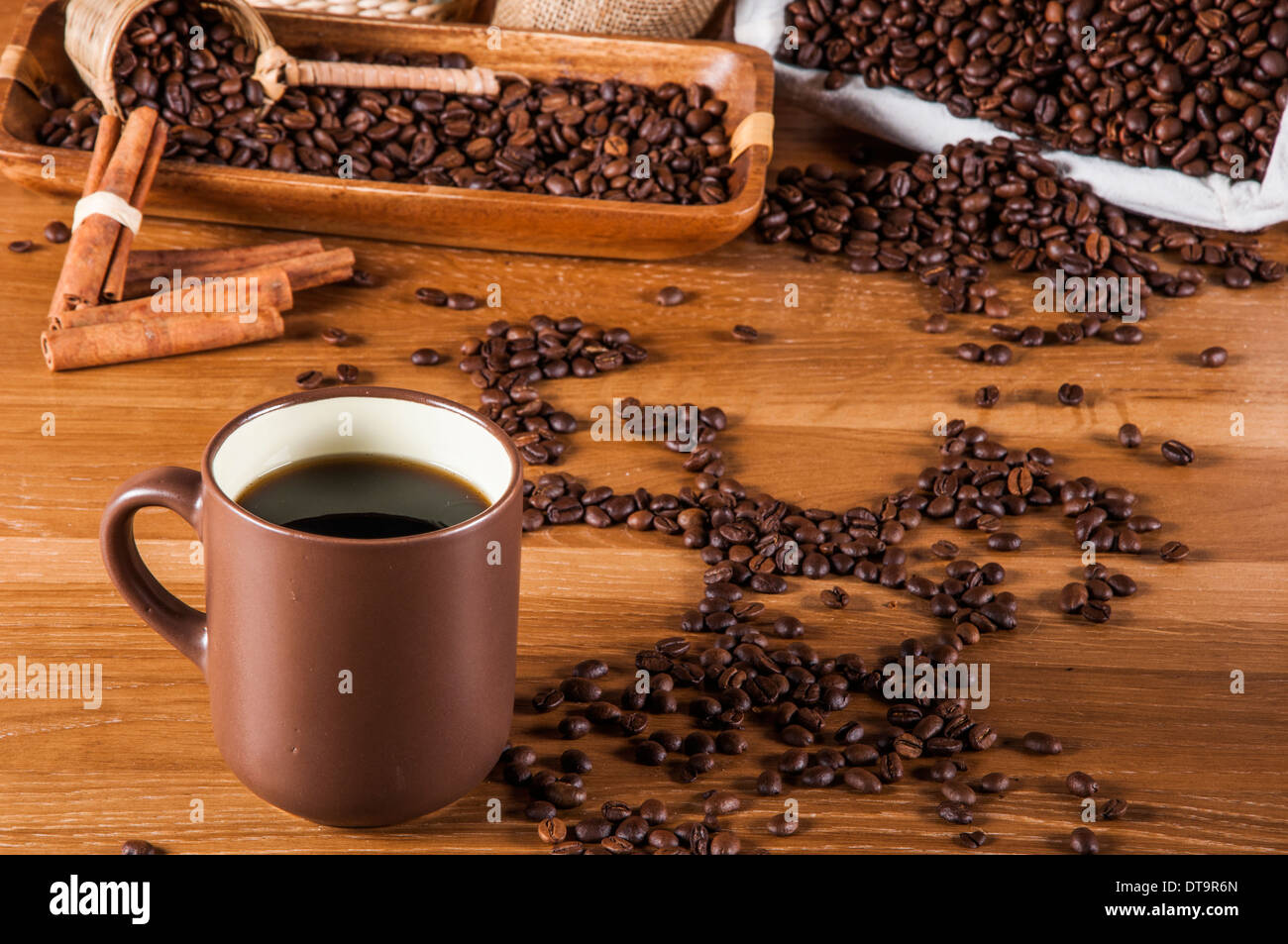 Coffee theme with wooden table and dark background Stock Photo - Alamy