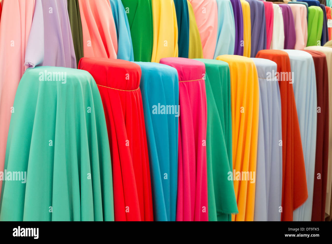 Rolls of brightly coloured fabrics and cloths Stock Photo - Alamy