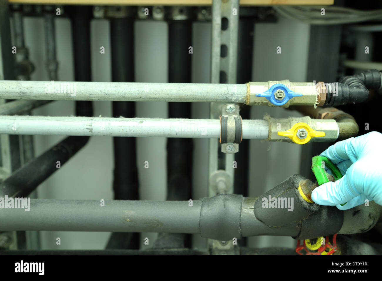 pipes and a hand on rotary knob Stock Photo - Alamy