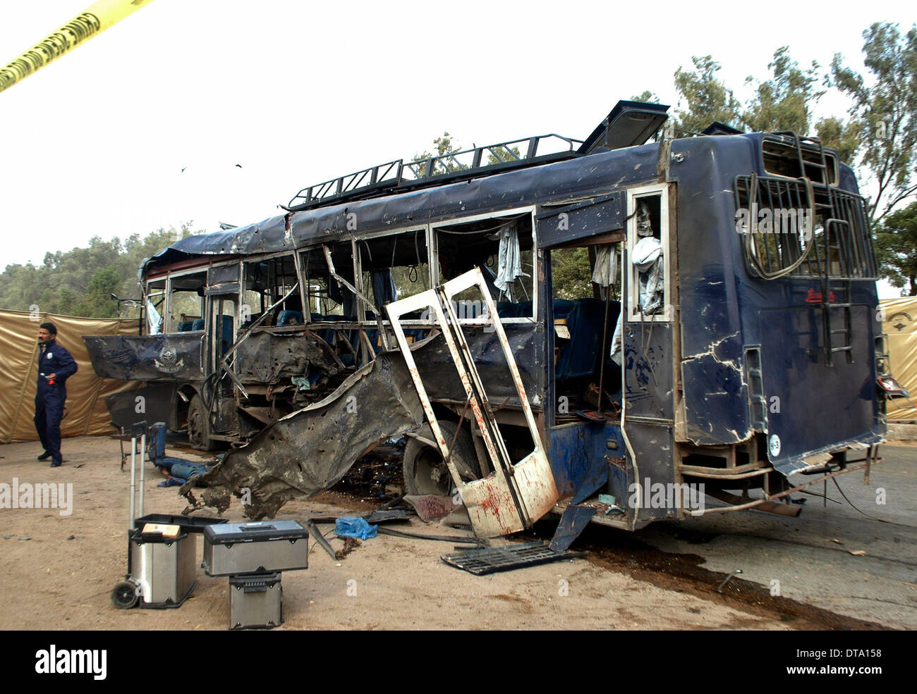 Karachi. 13th Feb, 2014. The wreckage of a destroyed police bus is seen ...