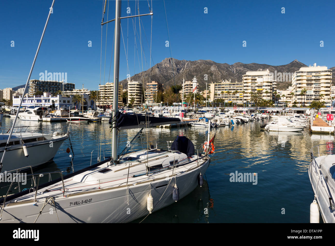 MARBELLA SPAIN THE HARBOUR WITH BOATS AND A SEAFRONT WITH A LIGHTHOUSE ...