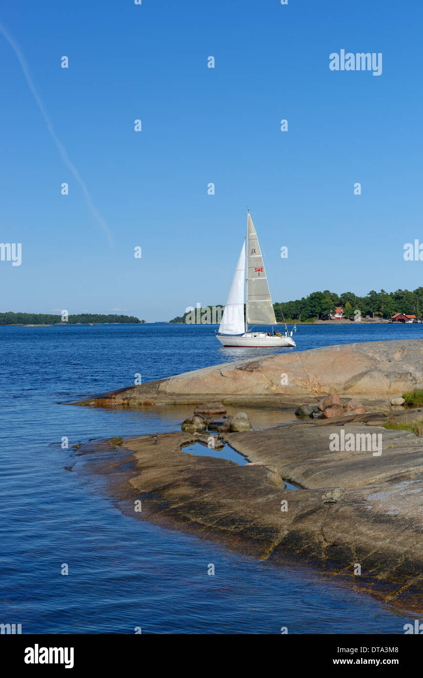 Sailboat and typical round polished rocks, roches moutonnées, on ...