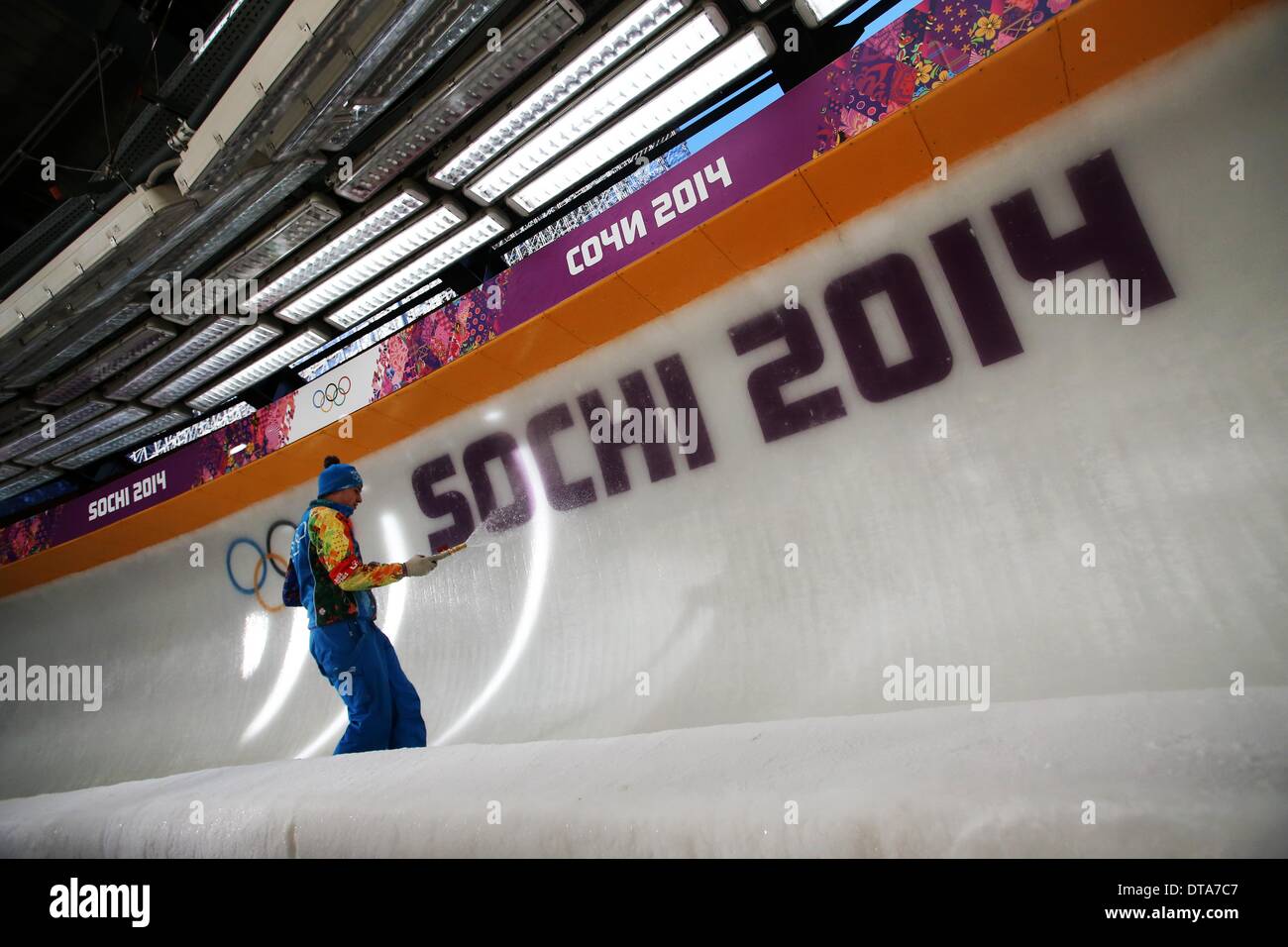 A worker prepares the track in Heat 1 in the women's Skeleton ...